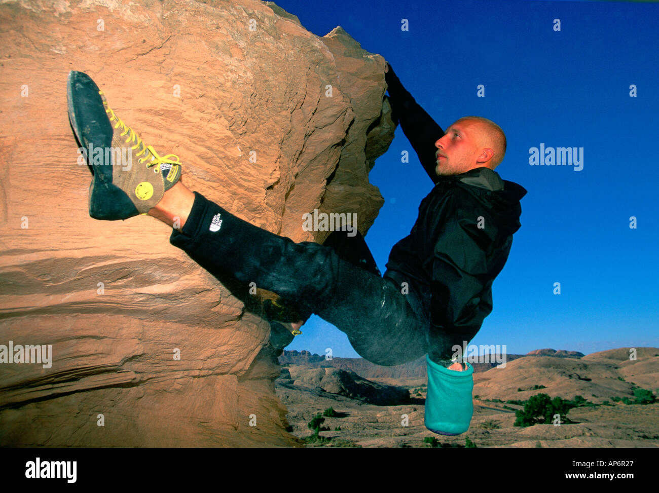 Rock climber hanging from cliff face in Fisher Towers, Colorado River ...