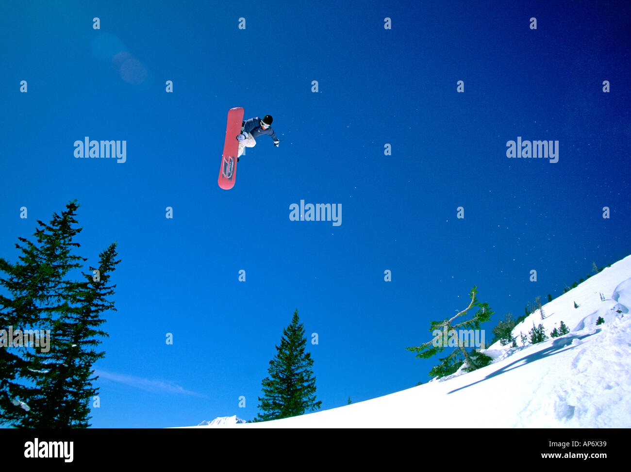 Mid air snow-boarding stunt and blue sky, Martin Rutz pulling a big air ...