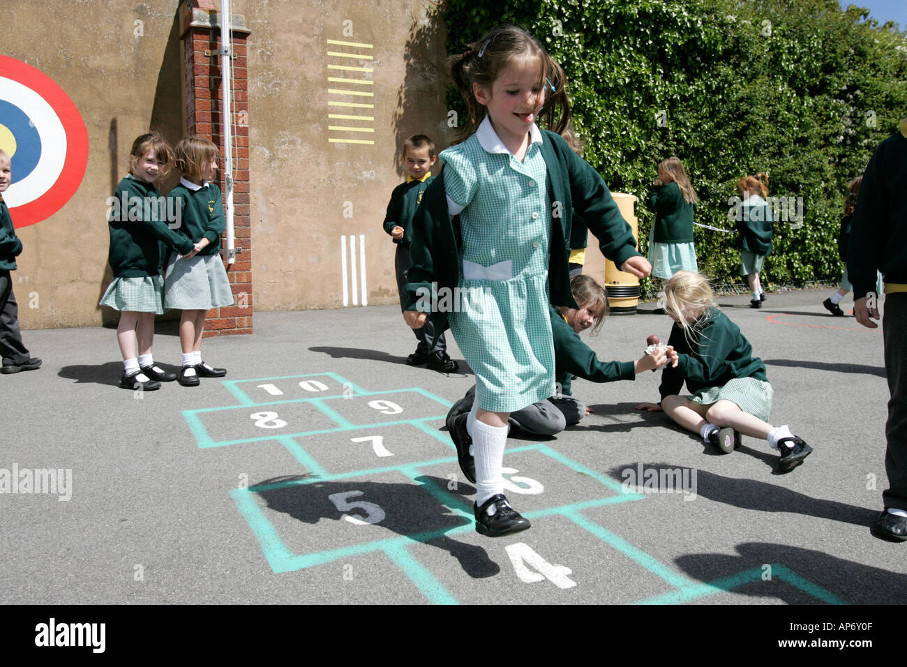 Primary Junior school children playing hopscotch in playground UK Stock ...