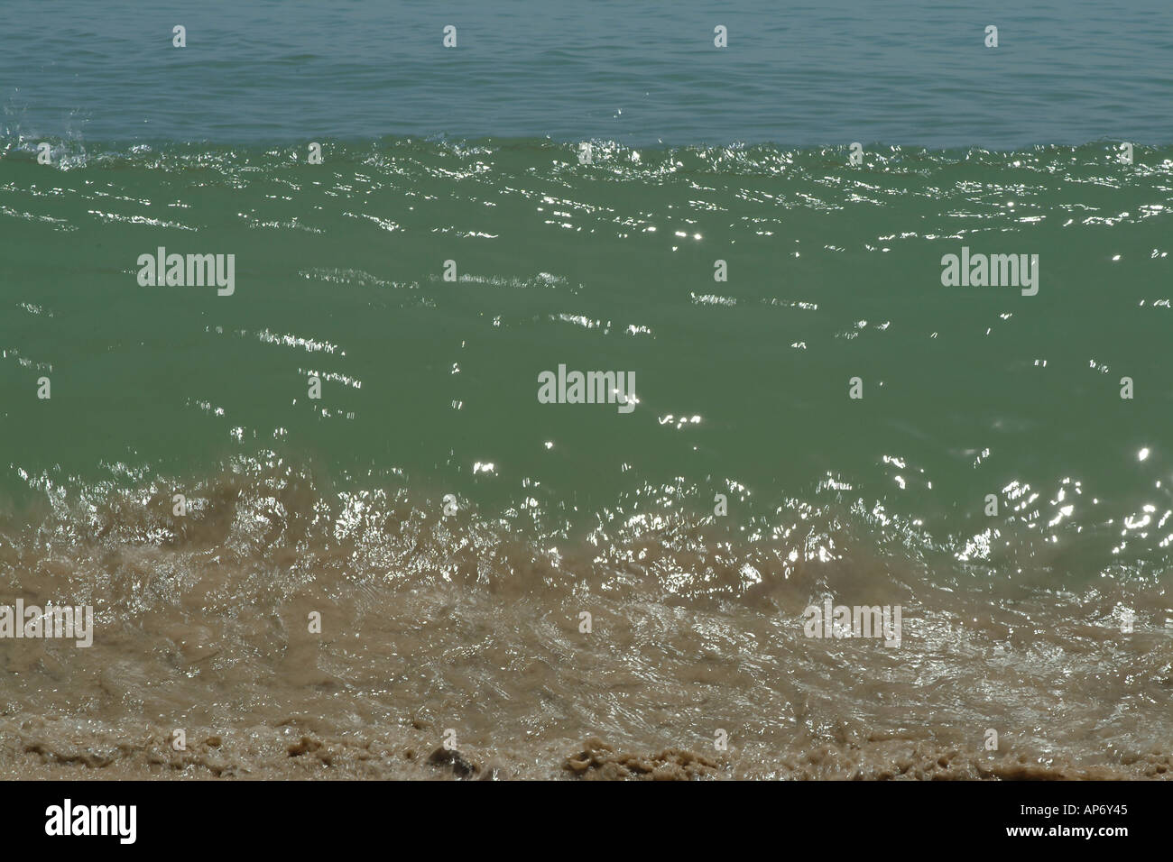 Wave breaks on a beach shoreline Stock Photo - Alamy