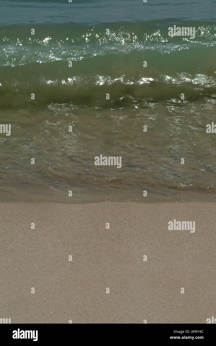 Wave breaks on a beach shoreline Stock Photo - Alamy