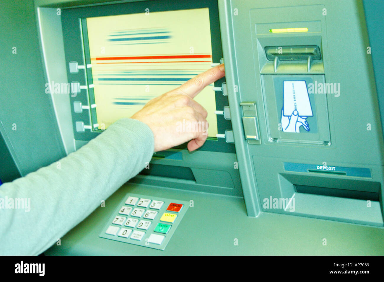 Hand using bank machine Stock Photo - Alamy