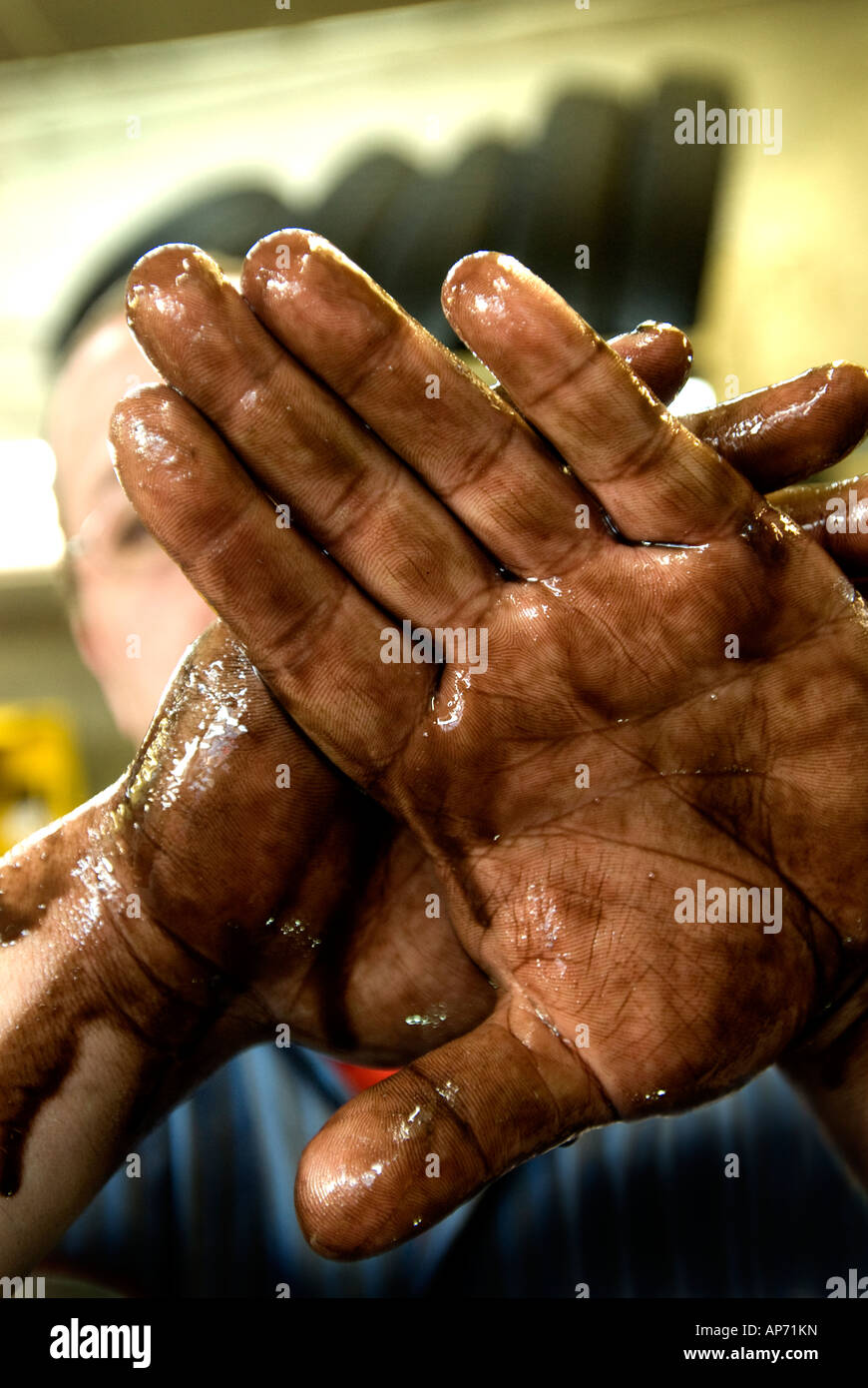 Workman's hands covered with oil in garage Stock Photo - Alamy