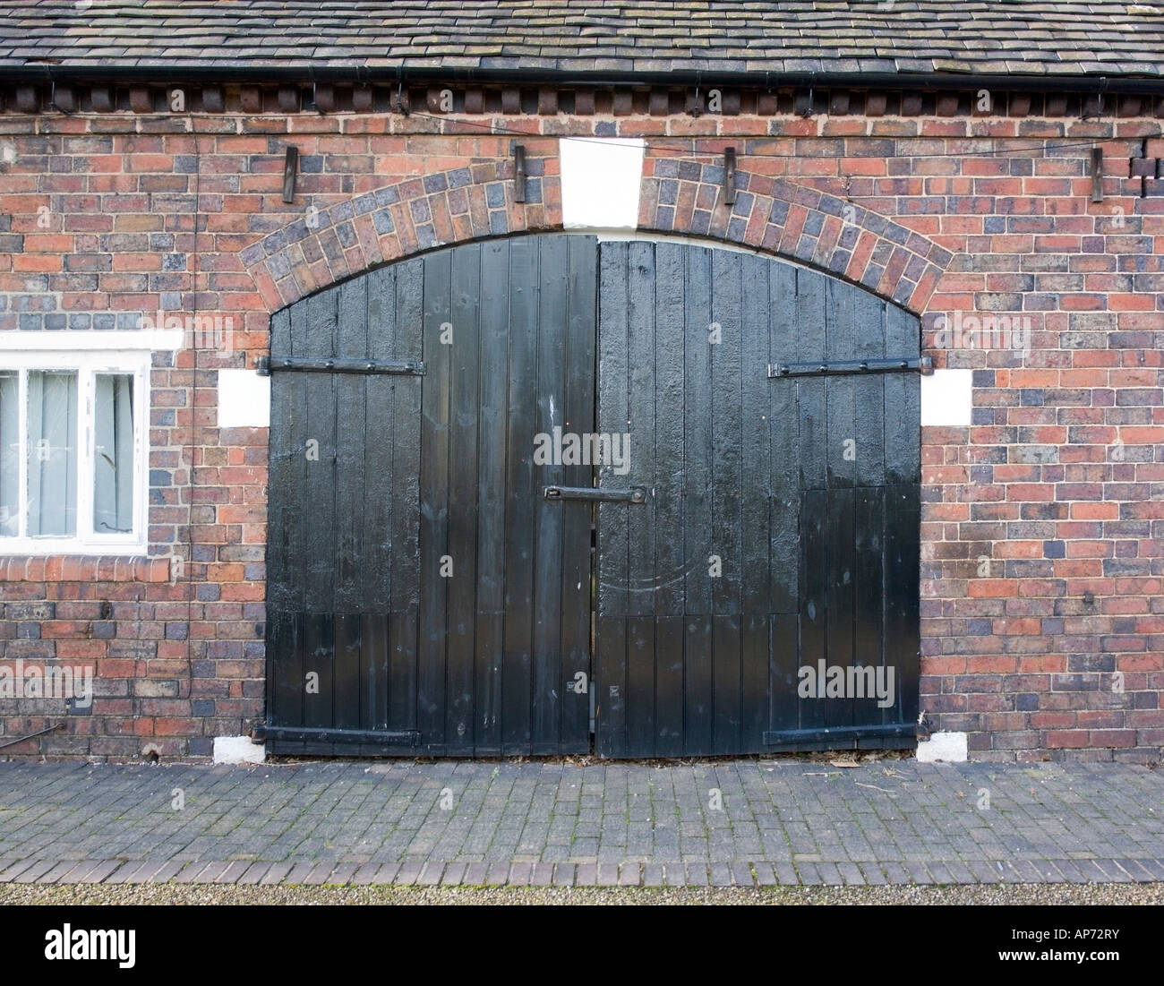 An old set of doors in a brick built building Stock Photo - Alamy