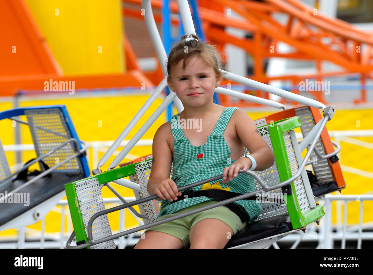 Youngsters ride a daring and fast ride at a carnival Stock Photo - Alamy