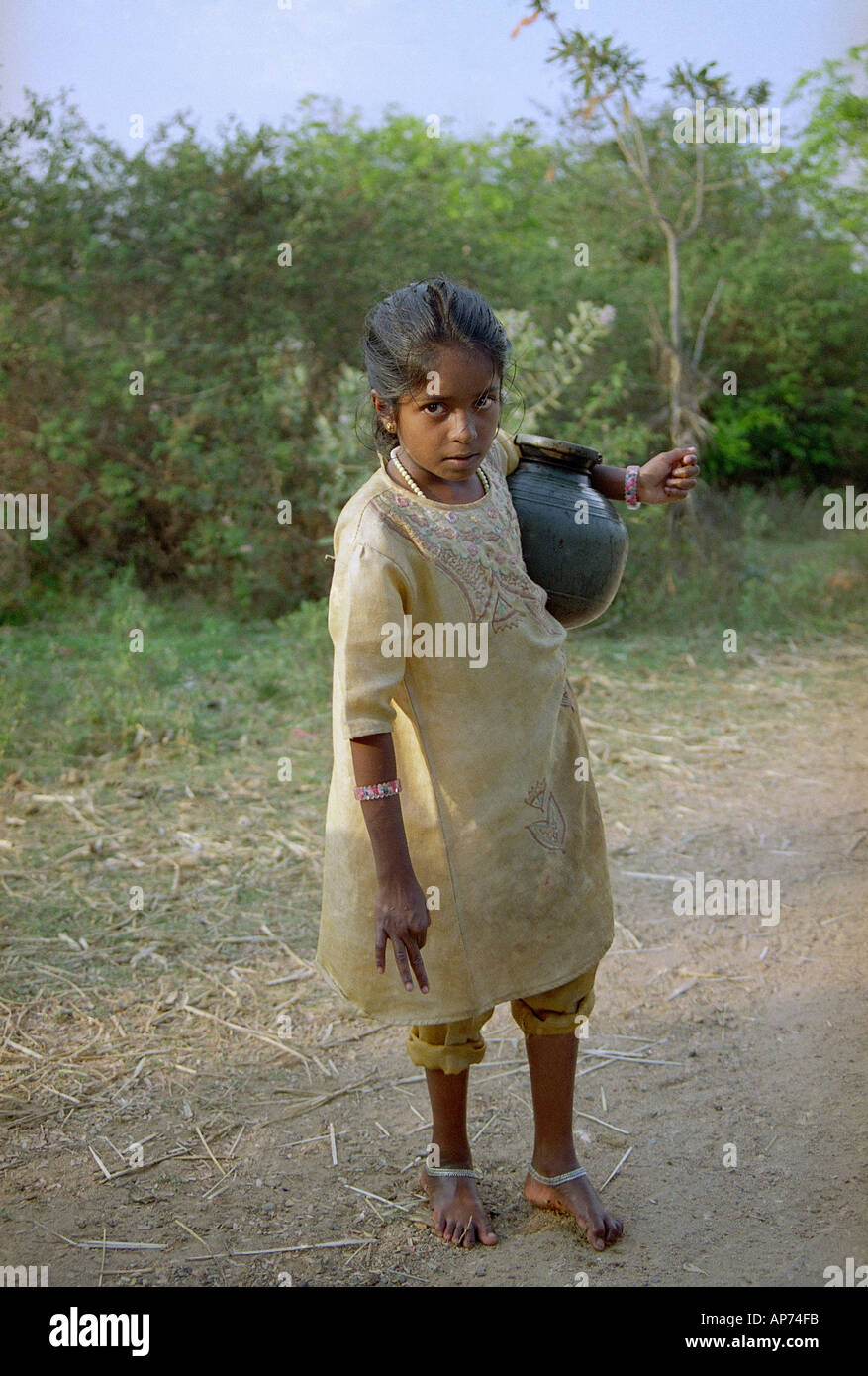 A rural girl carrying pitcher of water Stock Photo - Alamy