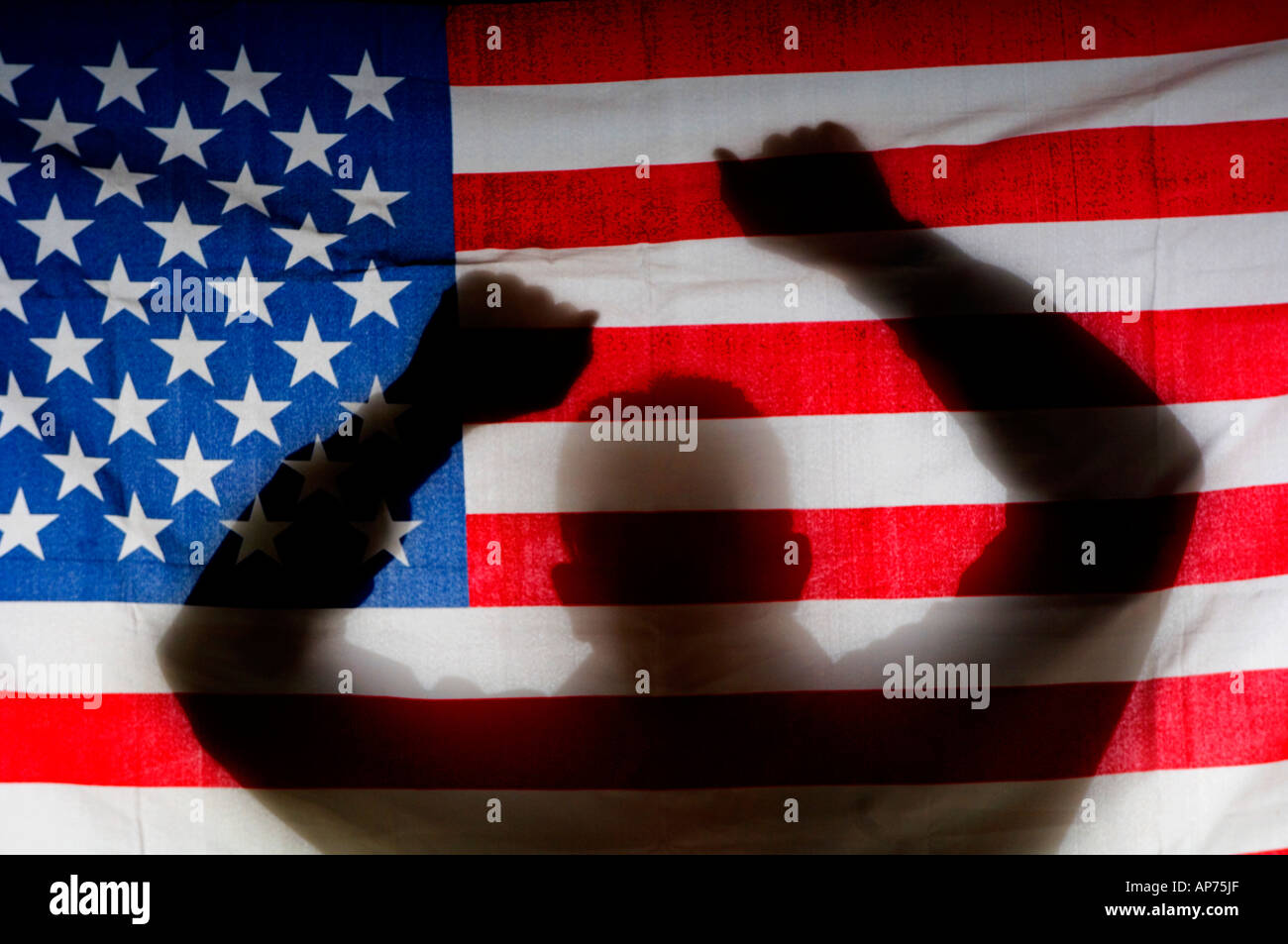 conceptual view of silhouette of a man behind United States flag in ...