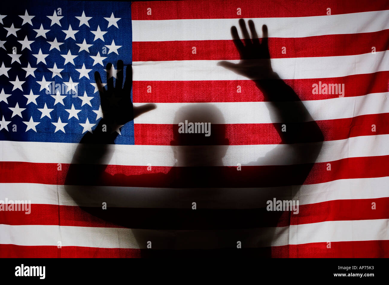 conceptual view of silhouette of a man behind United States flag in ...