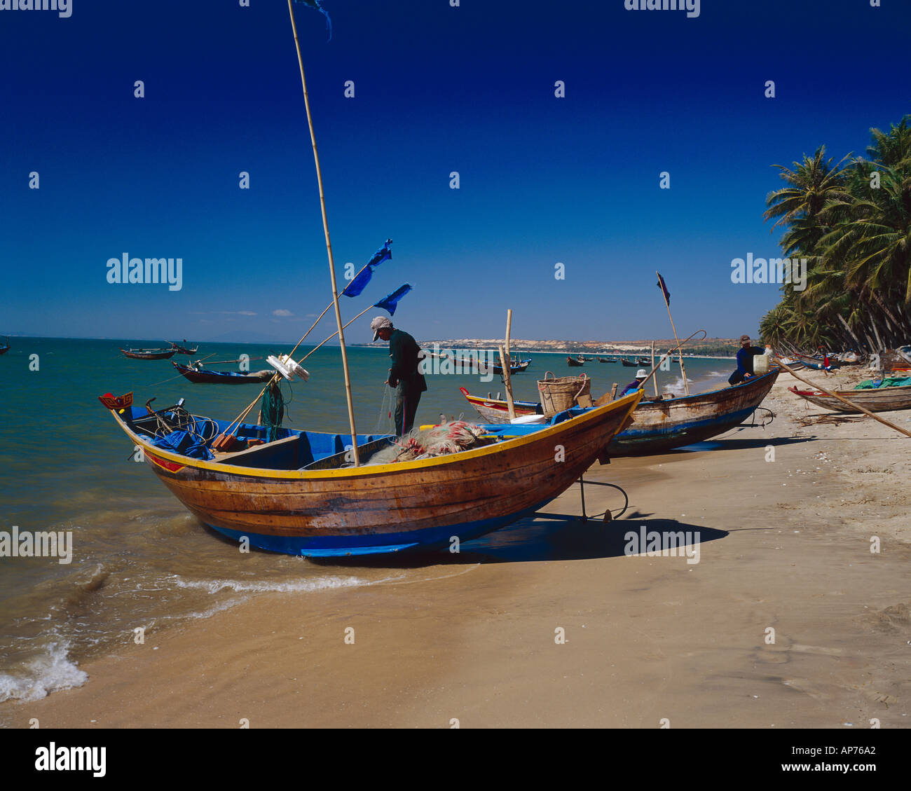 Mui Ne fishing village with fisherman sorting nets before going to sea ...
