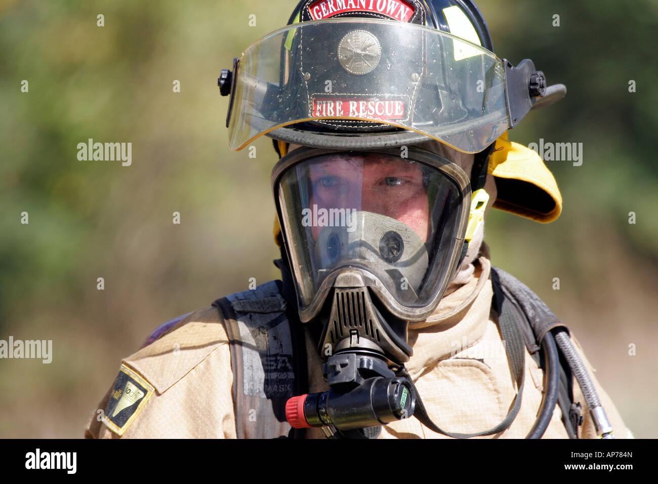 A fire rescue firefighter masked up in scba gear during the summer in ...