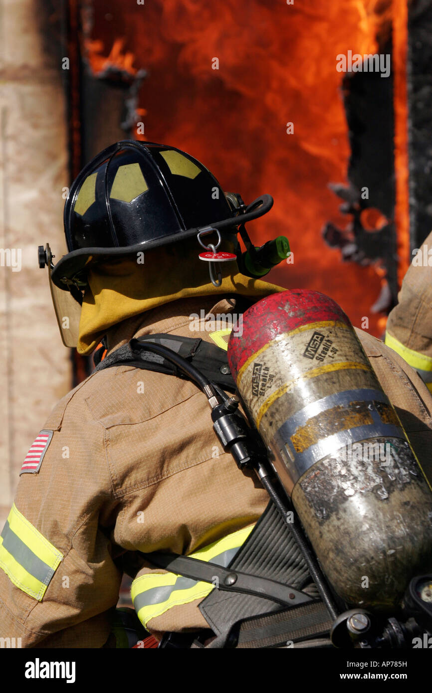 A firefighter ready to attack a structure fire Stock Photo - Alamy