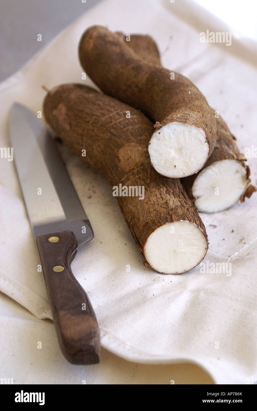 manioc roots on a white linen with a knife Stock Photo - Alamy