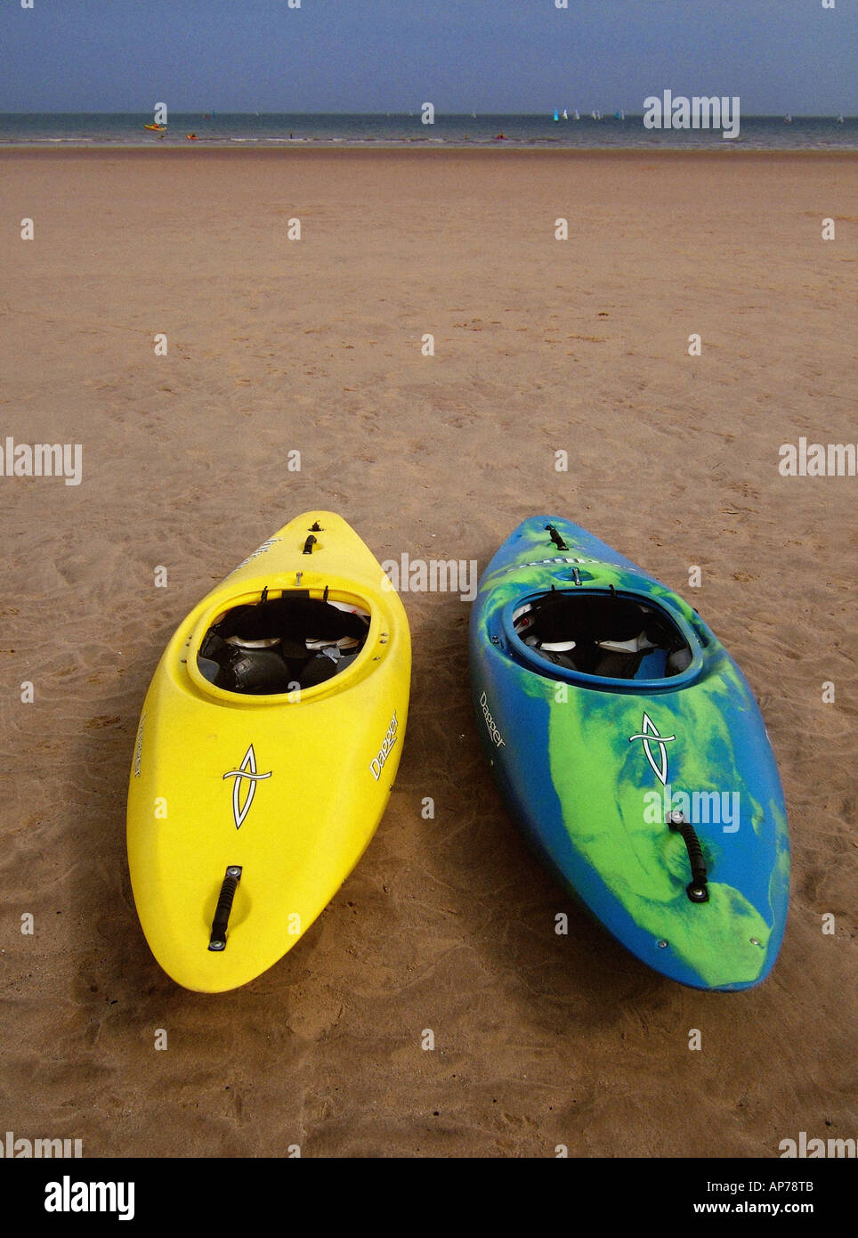 two kayaks on beach with sea in background Stock Photo - Alamy