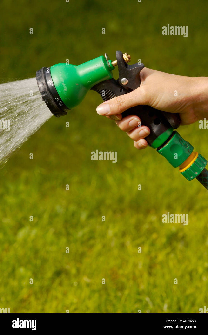 Hand holding hosepipe hi-res stock photography and images - Alamy