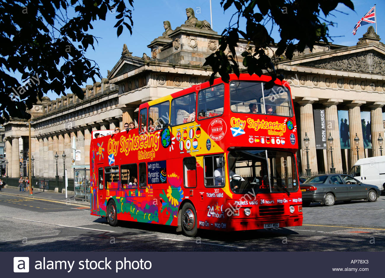 A red tourist bus passing the Royal Academy, The Mound Edinburgh ...