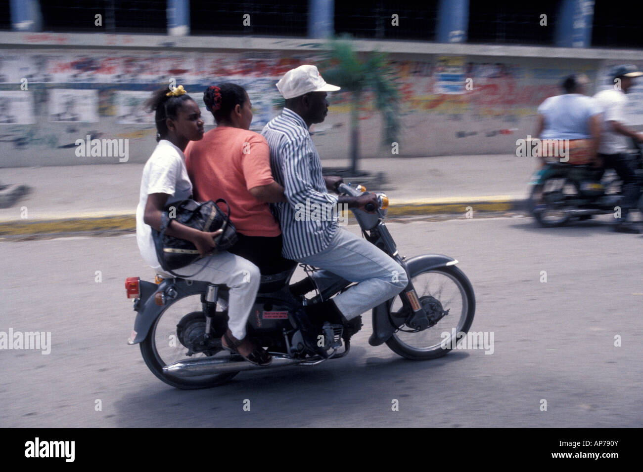 Three people riding a motorcycle High Resolution Stock Photography and ...