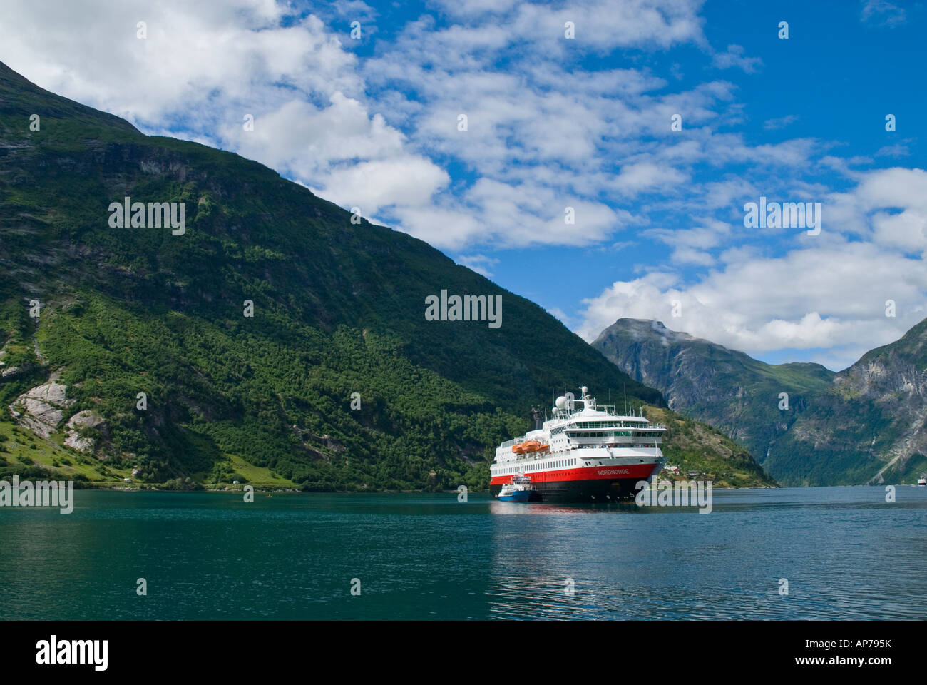 Hurtigruten passenger ferry at port in Geiranger and surrounded by the ...