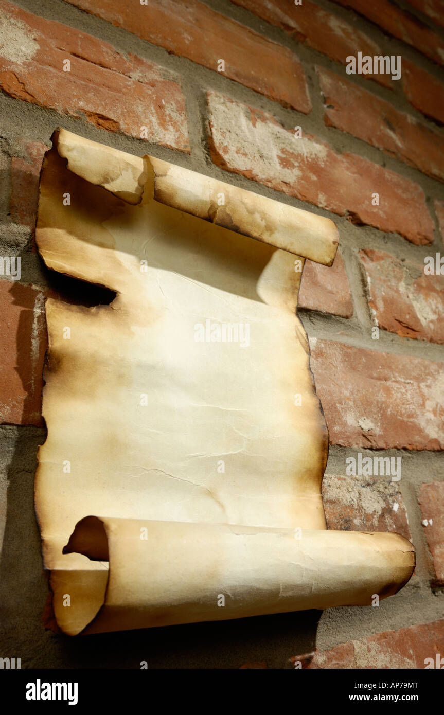 Old blank parchment with burnt edges on a red brick wall Stock Photo ...