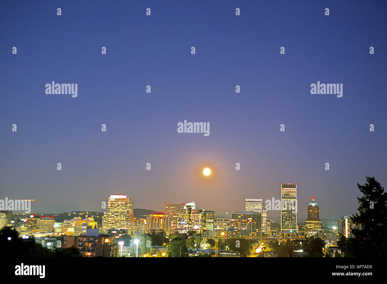 Harvest moon rising over the buildings and skyscrapers of downtown ...
