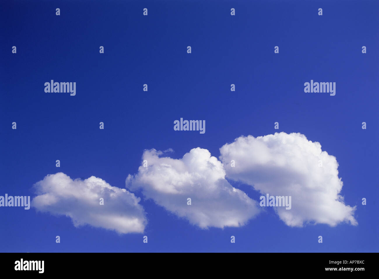 Family of three clouds passing through clear blue skies Stock Photo - Alamy
