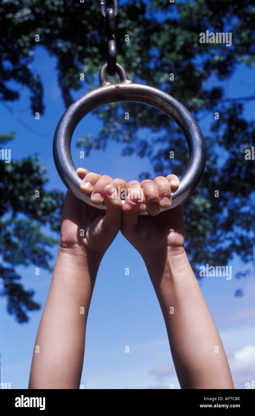 Child hanging on to a ring Stock Photo - Alamy