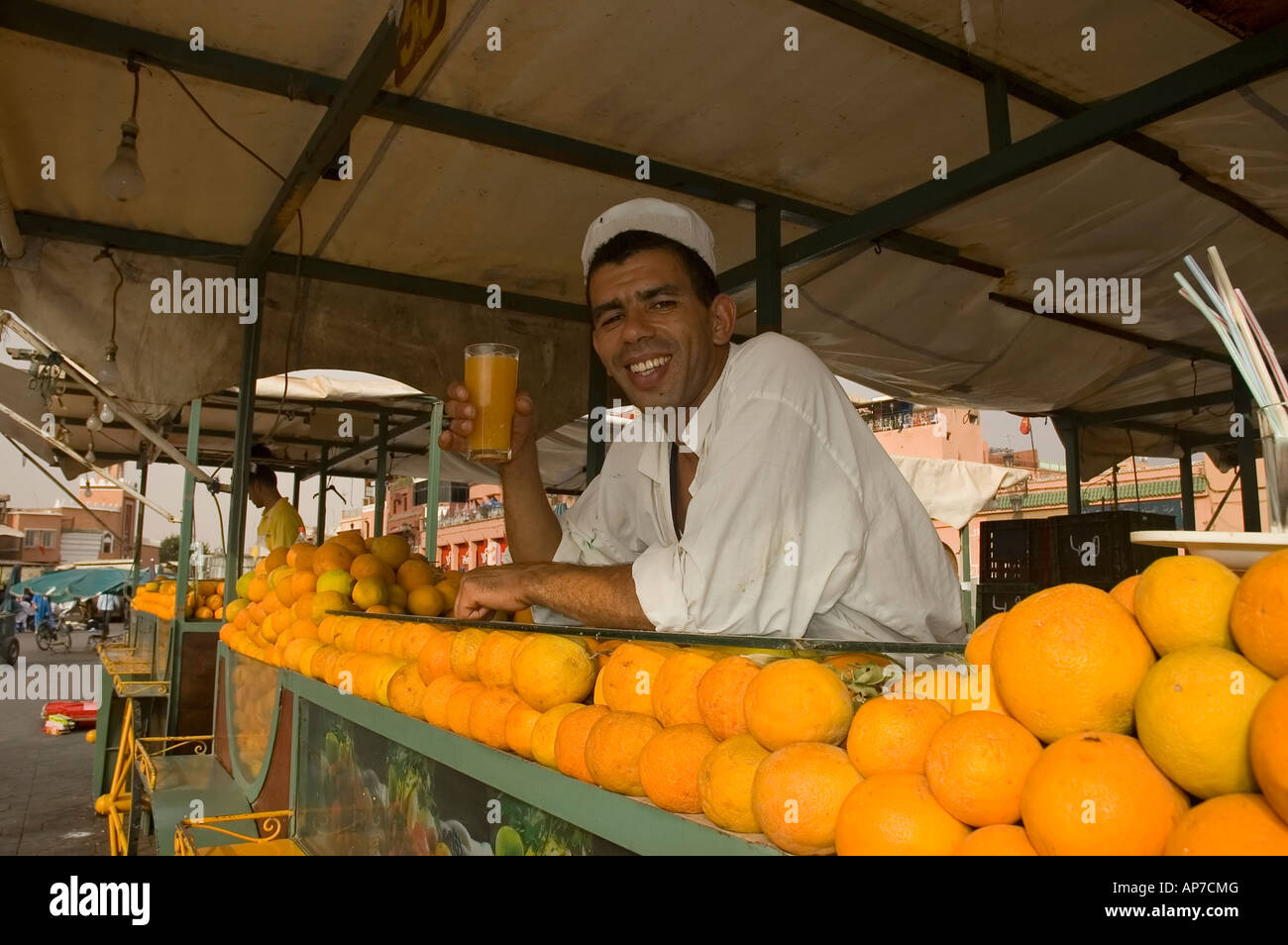 Smiling seller of orange juice in Djemaa el Fna main square of ...