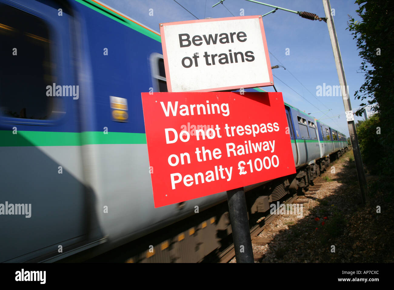 Train and warning signs at the railway crossing, Frinton-on-Sea, Essex ...