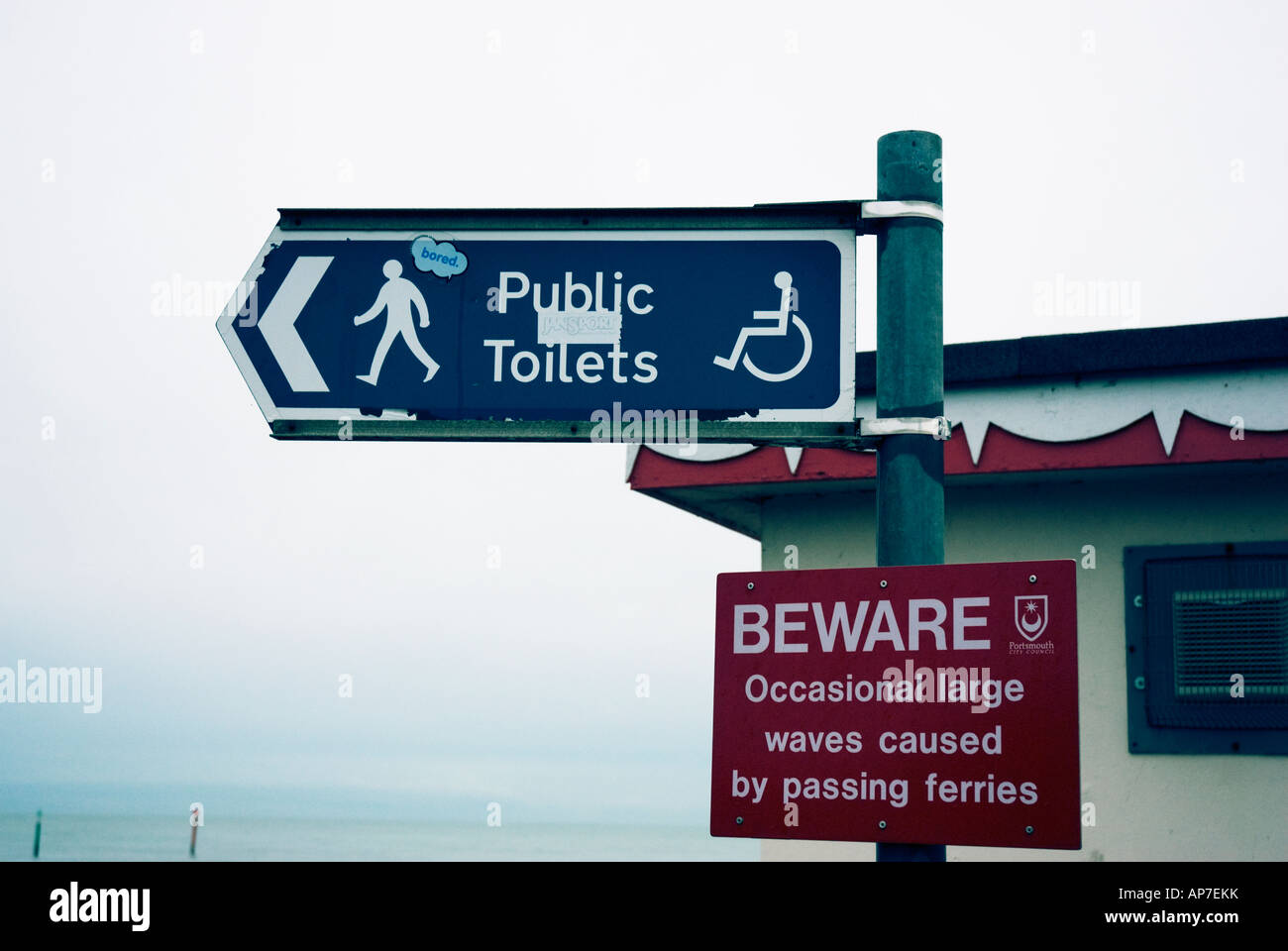 Toilet sign and beware of ferry sign Stock Photo - Alamy