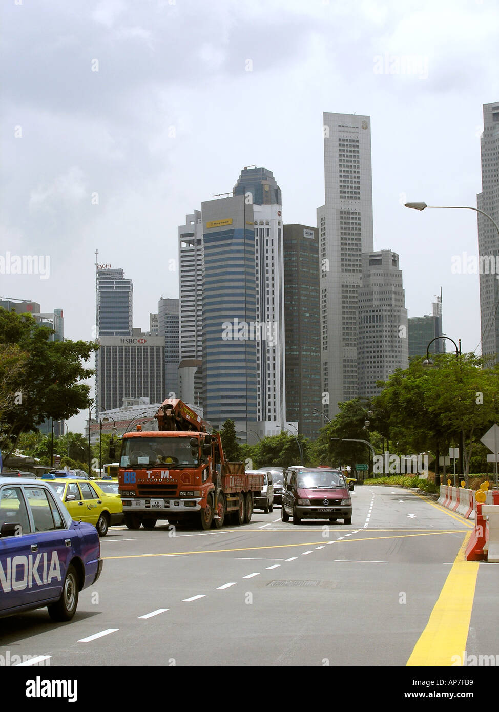 Singapore traffic with city skyline in background Stock Photo - Alamy