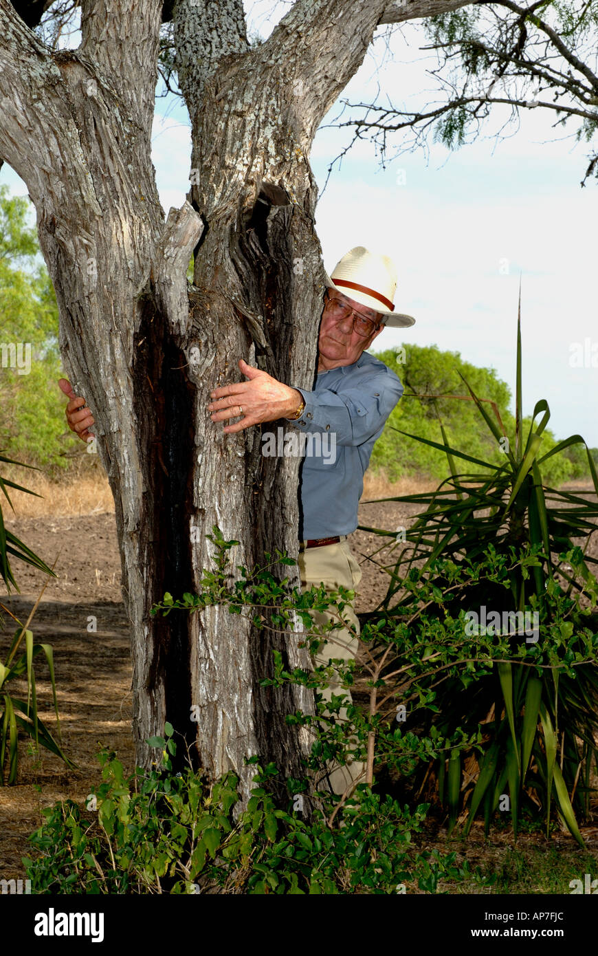 Old man hugs one of his favorite trees. Trees are being destroyed at an ...