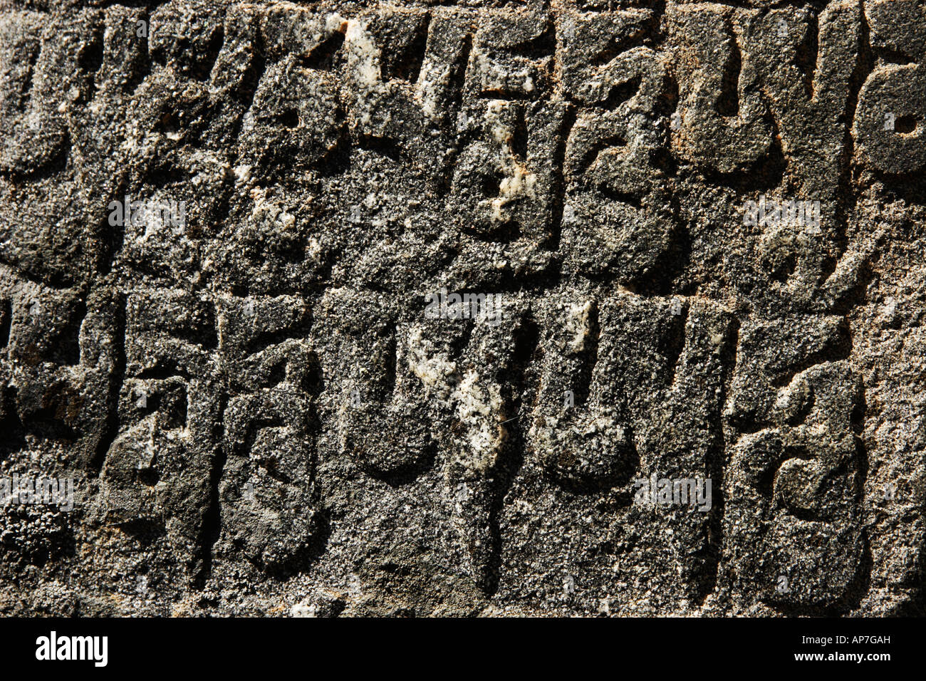 Tibetan inscriptions on a mani stone Stock Photo - Alamy