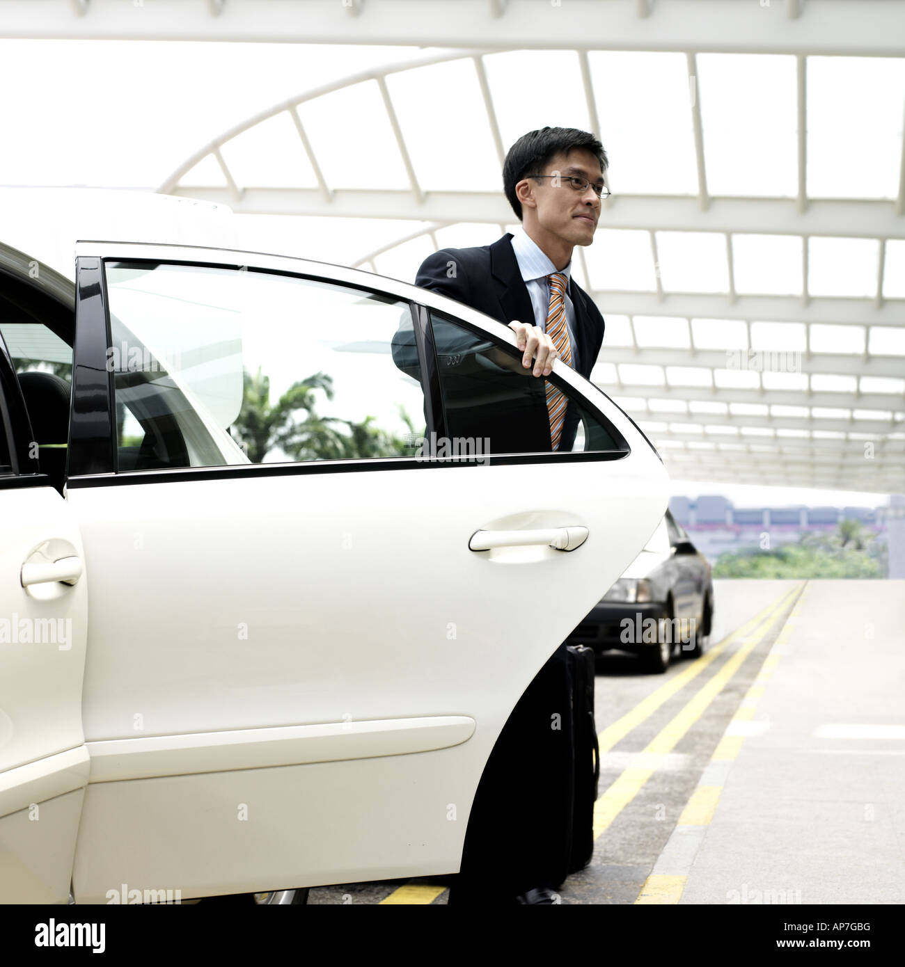 Businessman arriving at airport by car Stock Photo - Alamy