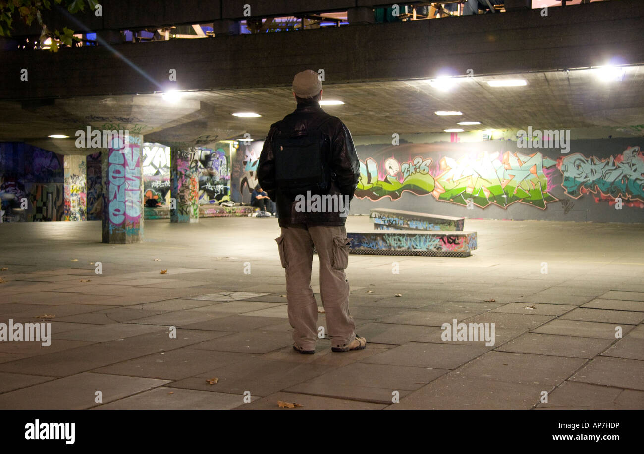 man looking at graffiti Stock Photo - Alamy