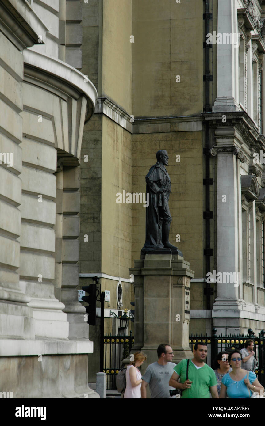 Tourists passing classical buildings and statue in Whitehall London ...