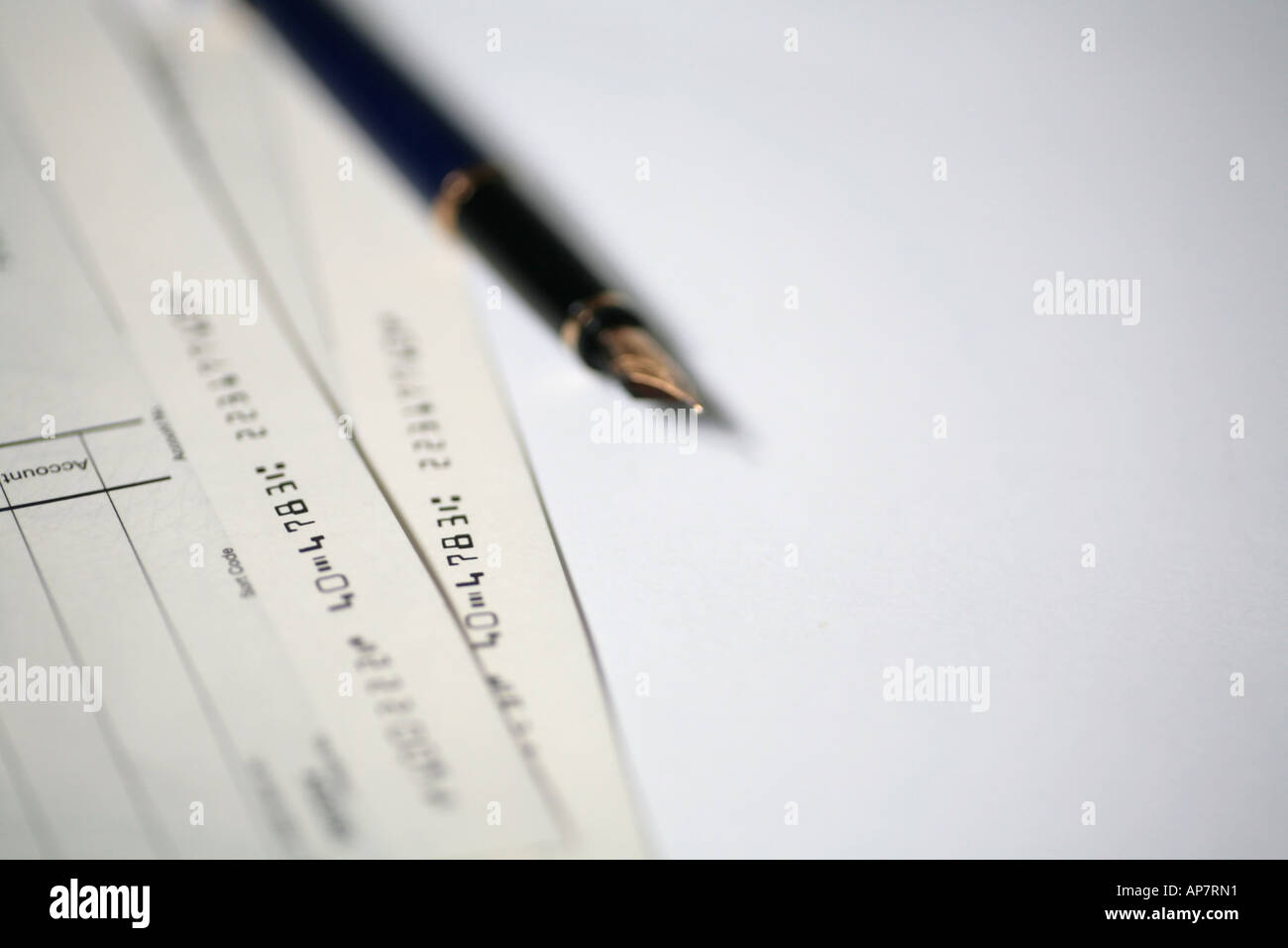 cheques and pen Stock Photo - Alamy