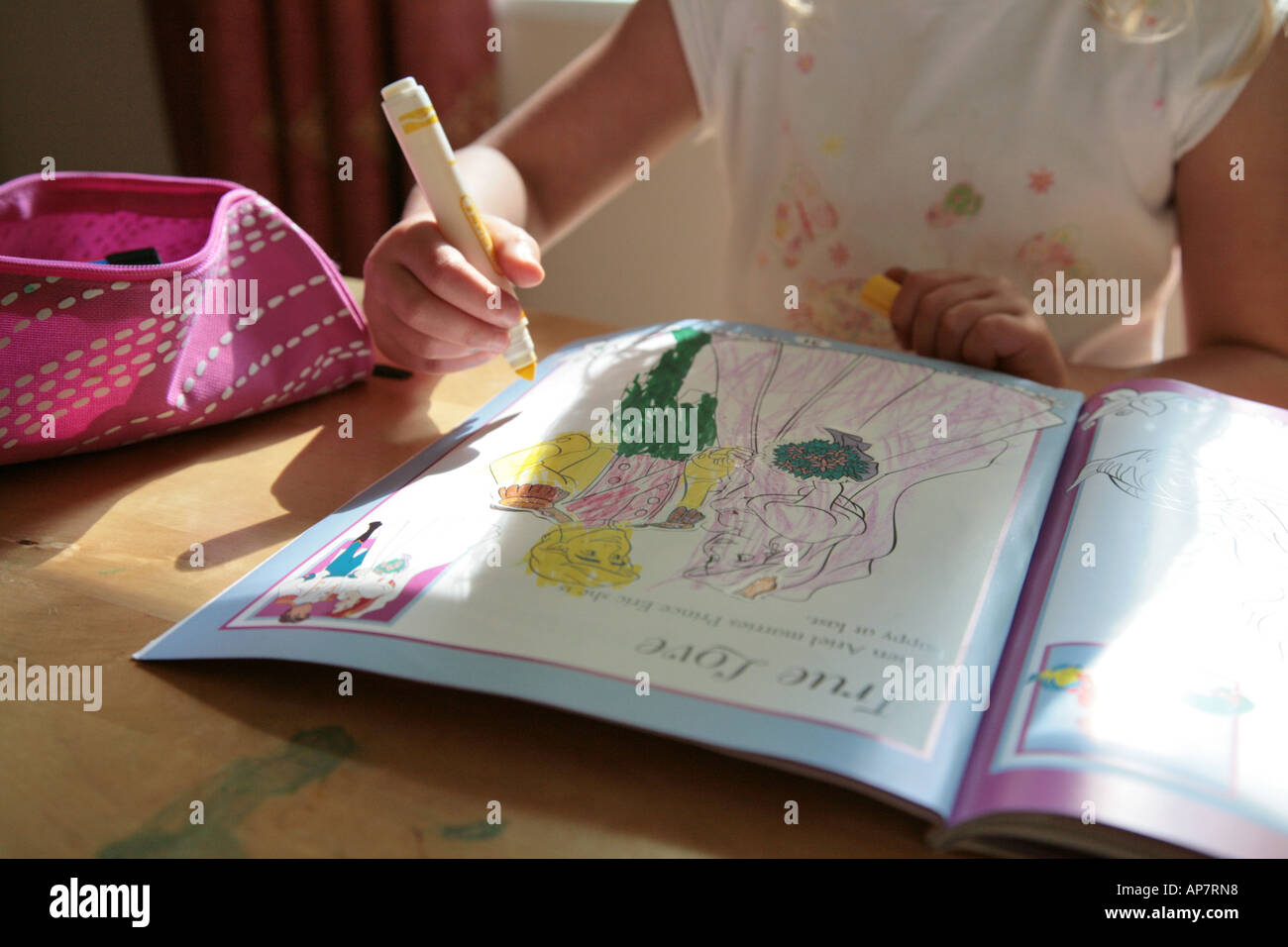 Young child using colouring book Stock Photo - Alamy