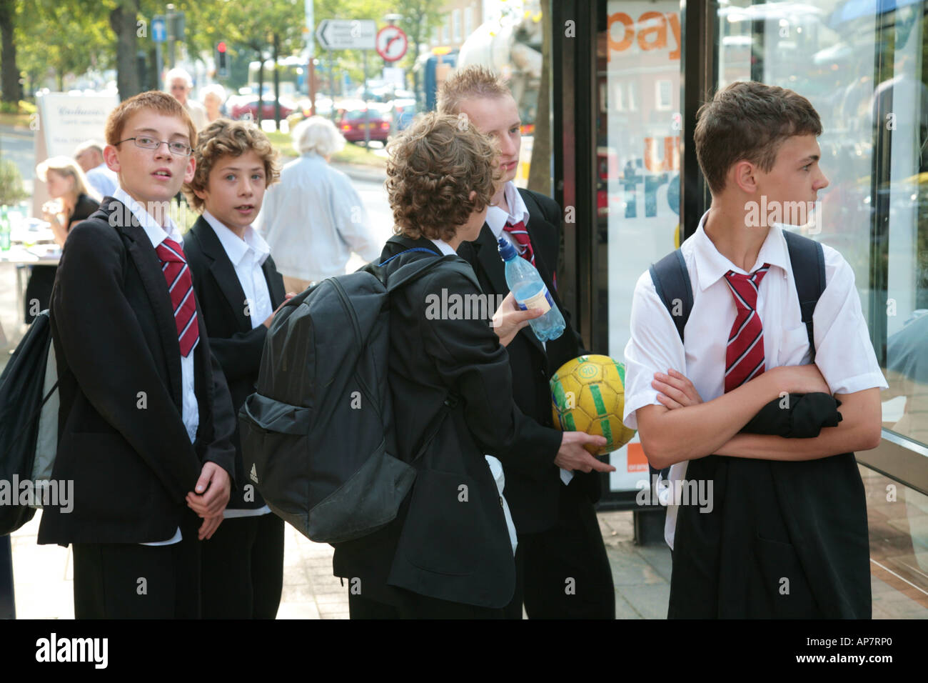 school boys waiting at bus stop Stock Photo - Alamy