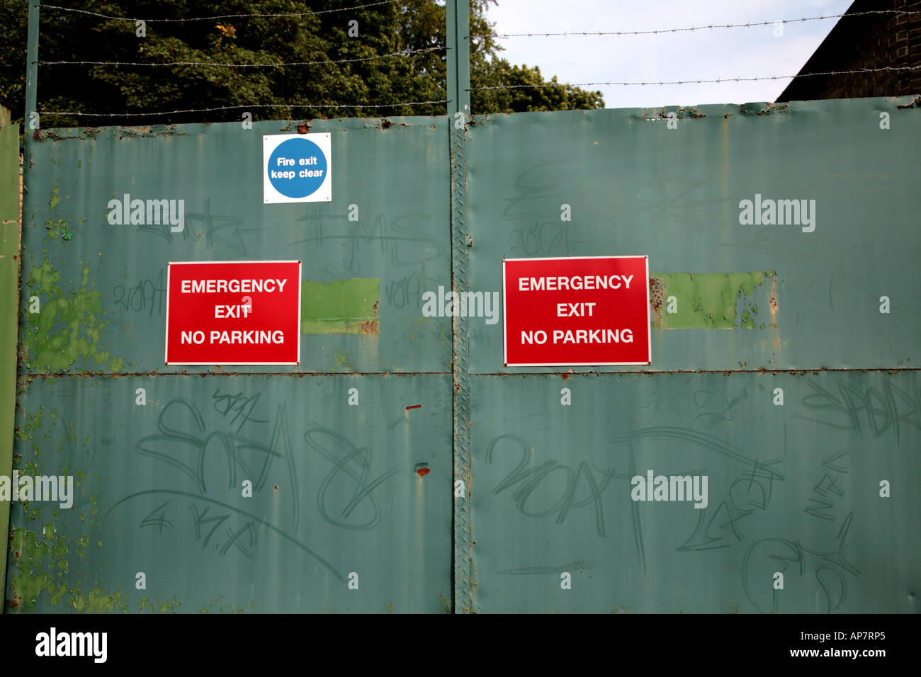 emergency exit signs on green gate Stock Photo - Alamy