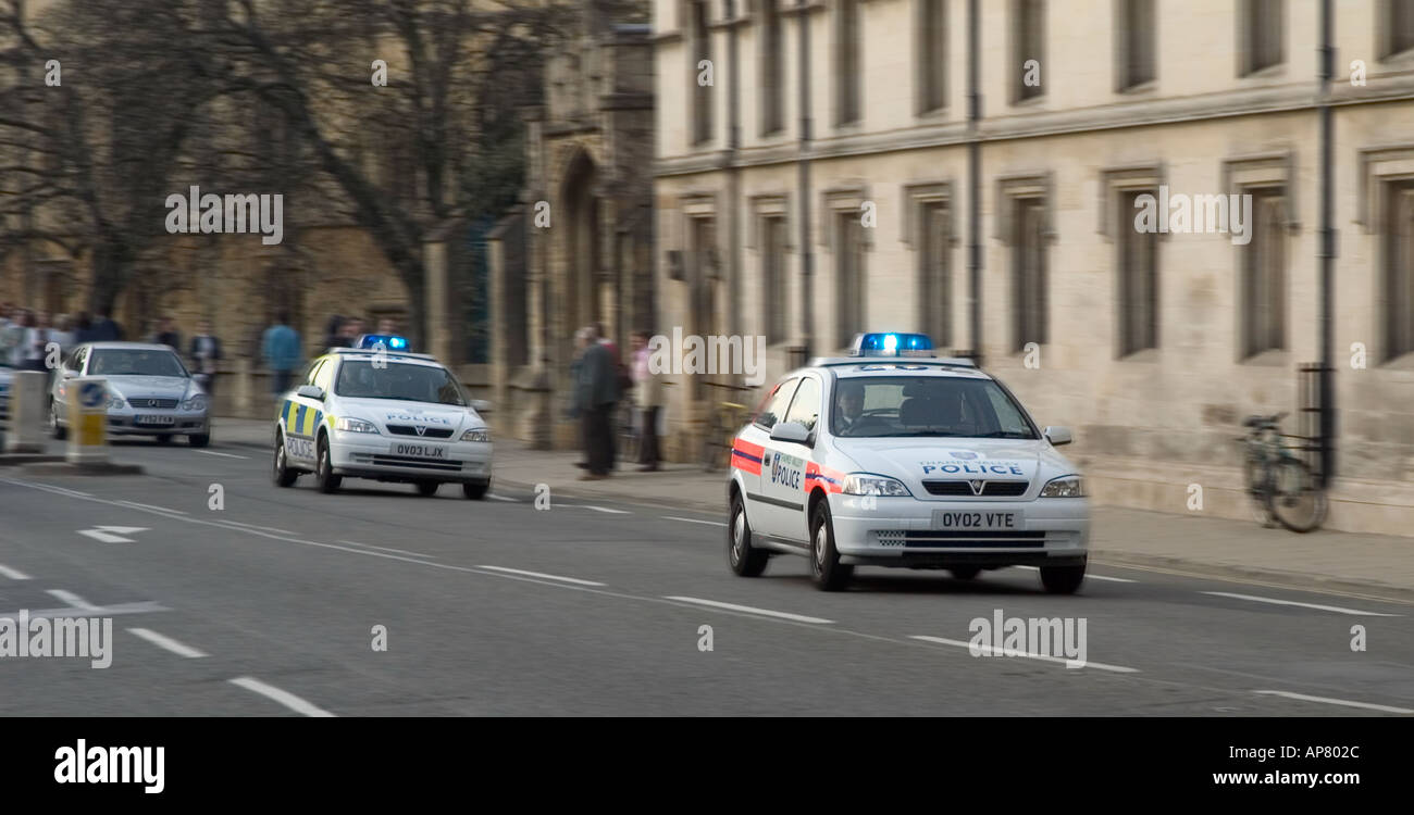 Thames valley police cars travelling past Magdalen College Oxford Stock ...