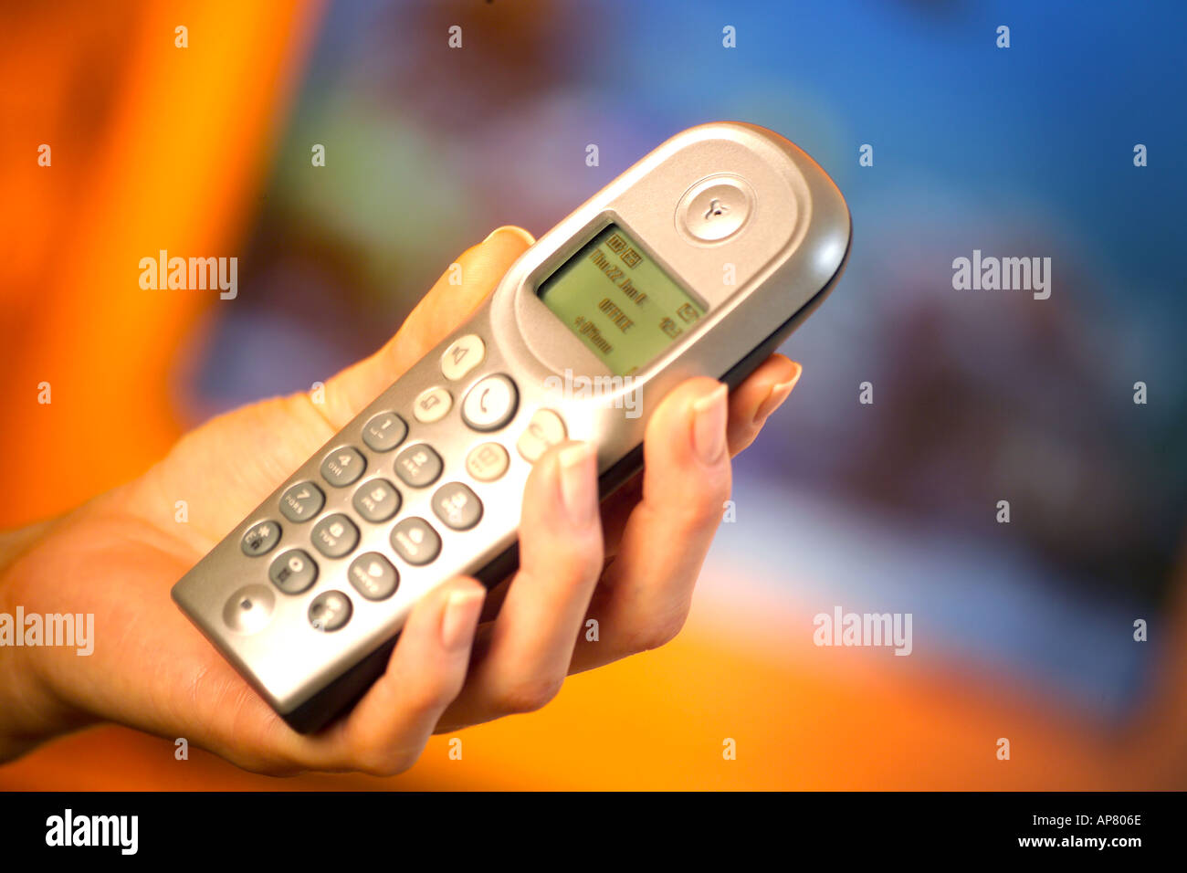 Hand holding telephone of computer screen Stock Photo - Alamy