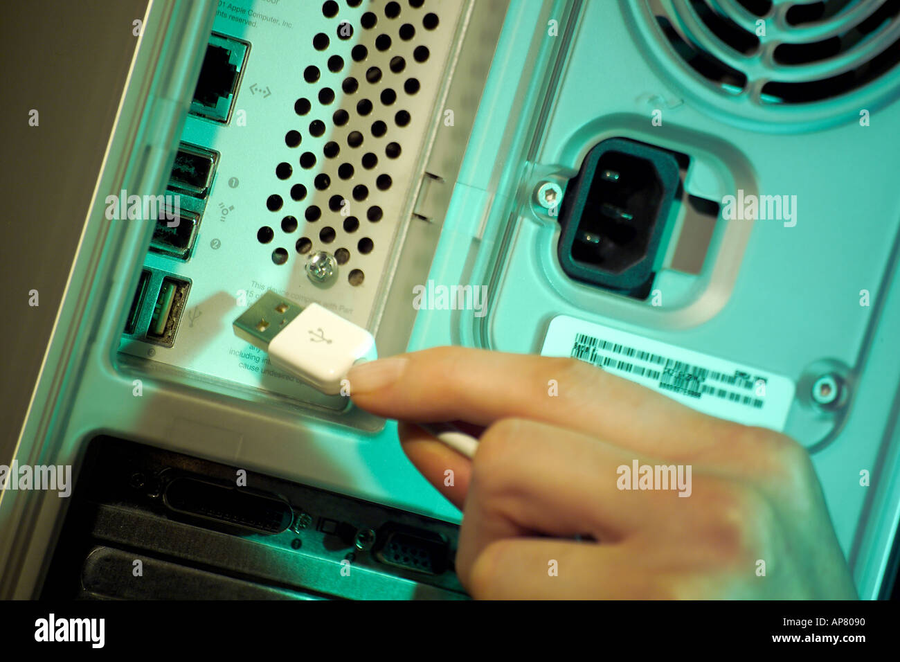 Hand plugging in USB plug into back of a computer Stock Photo - Alamy