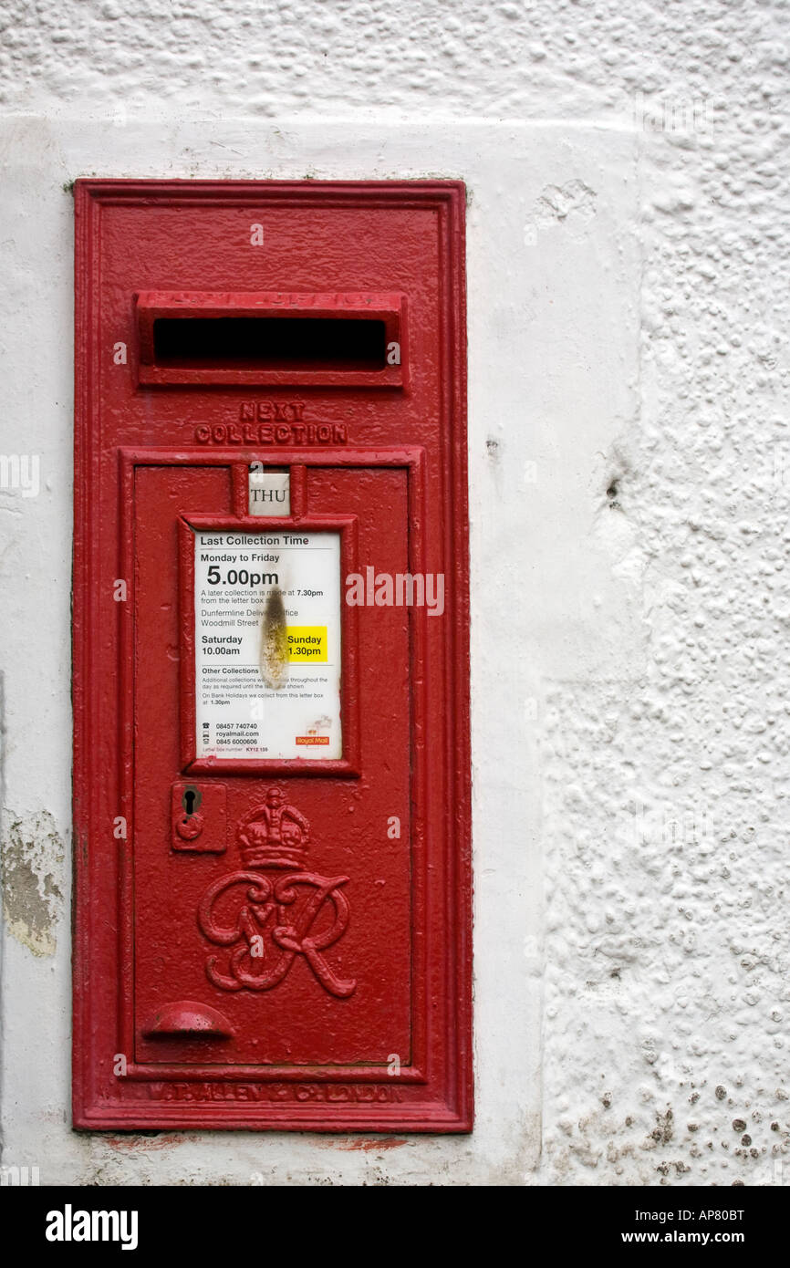 Royal Mail red letter box on a white roughcast wall Stock Photo - Alamy