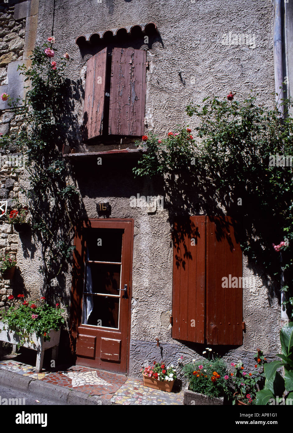 Traditional Provencal house with wooden shutters and flower boxes St ...