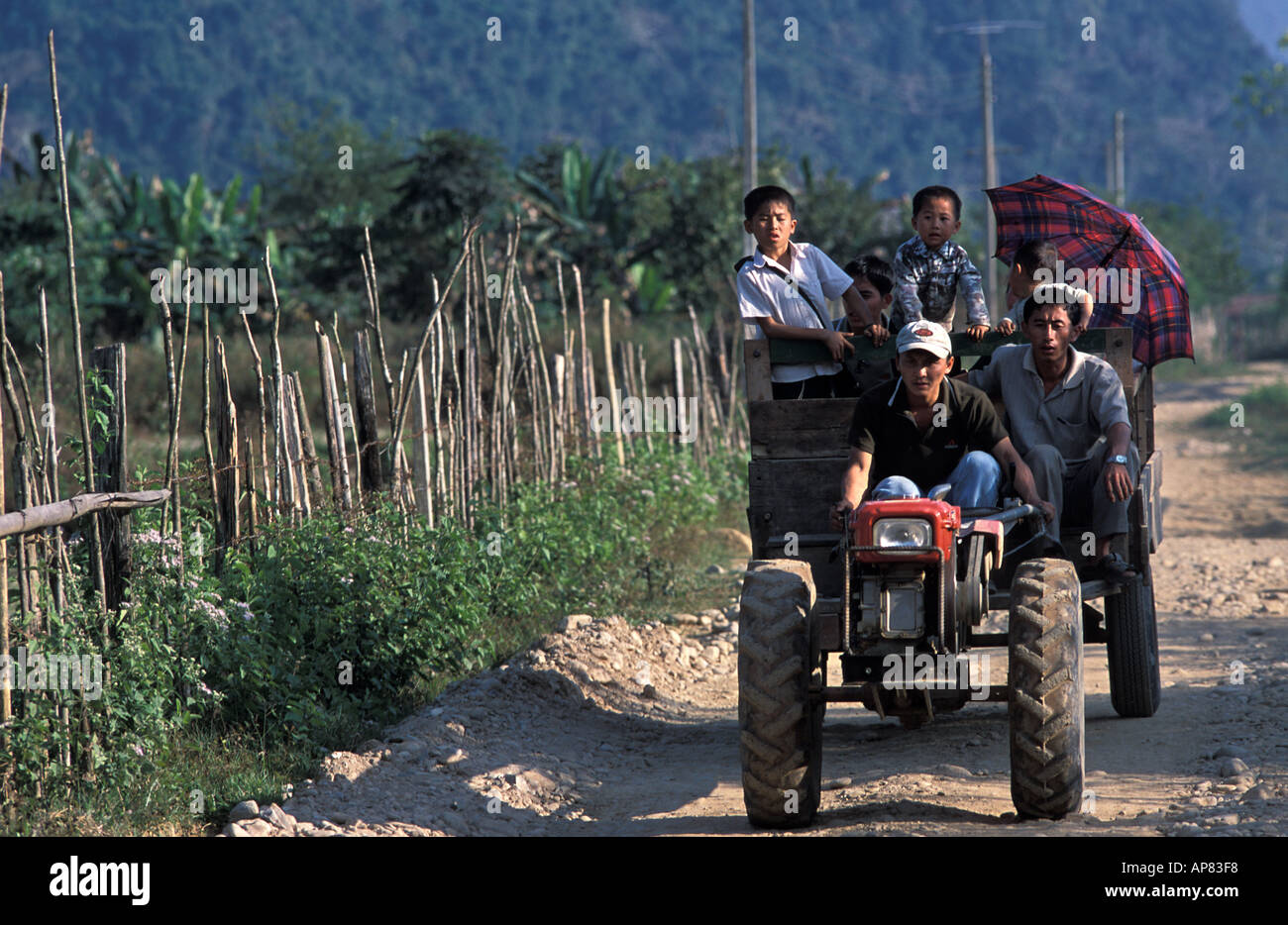 Driving tractor driven passenger cart on rural road nr Tham Poukham W ...