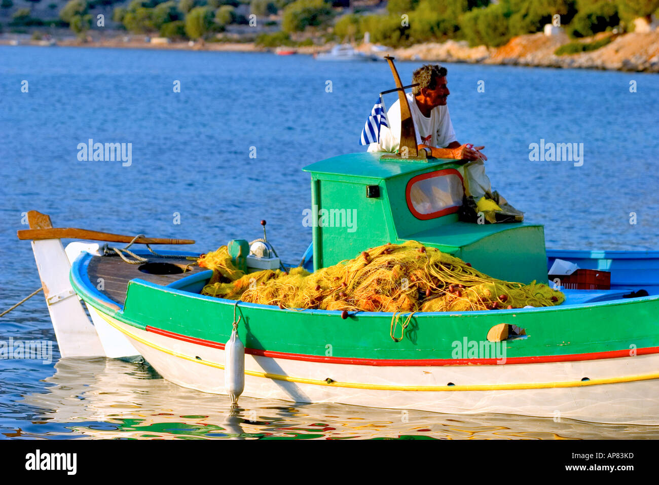 fishing rowing with fisher man inside preparing fishnet in symi ...