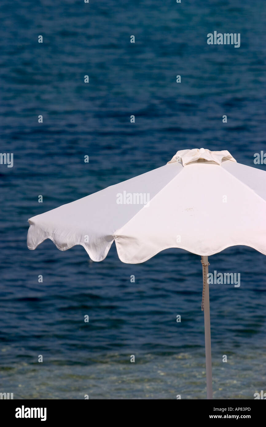 under a white parasol greece Stock Photo - Alamy