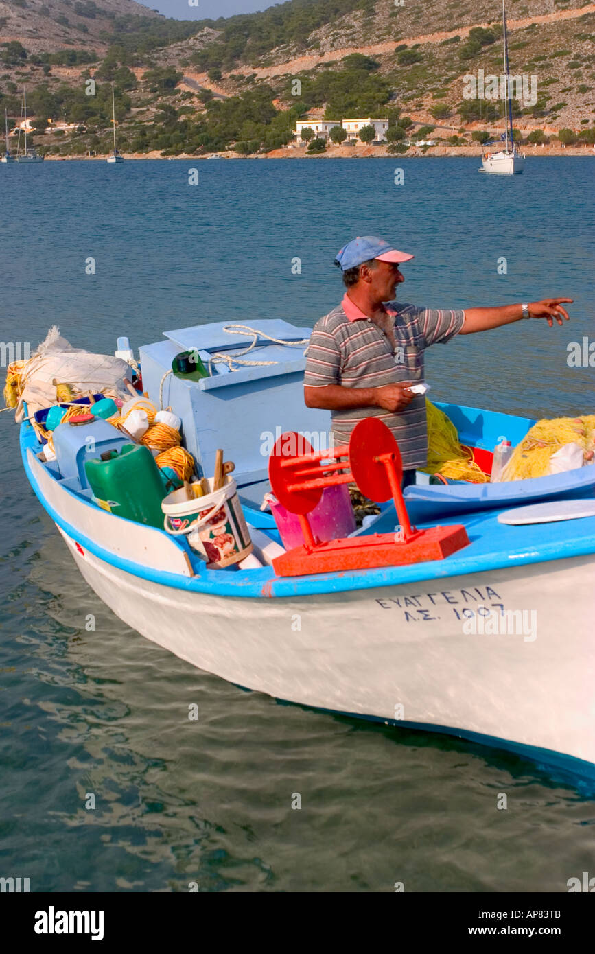 fishing rowing with fisher man inside preparing fishnet in symi ...