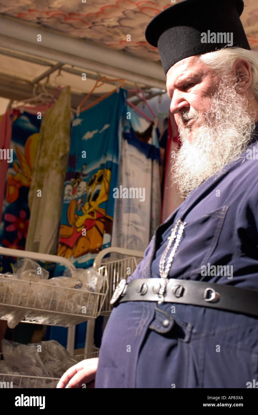 Portrait of black dressed Greek Orthodox clergyman wearing hat beard ...