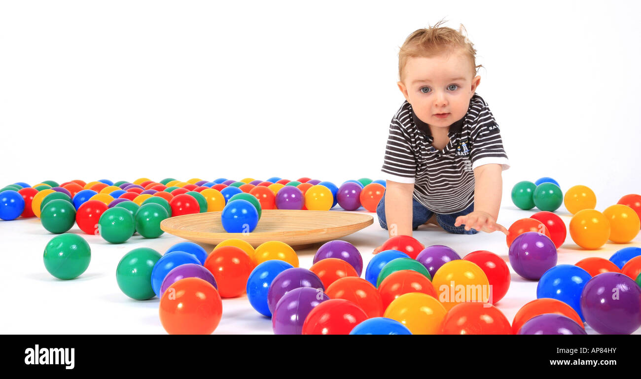 Small boy playing with coloured balls hi-res stock photography and ...