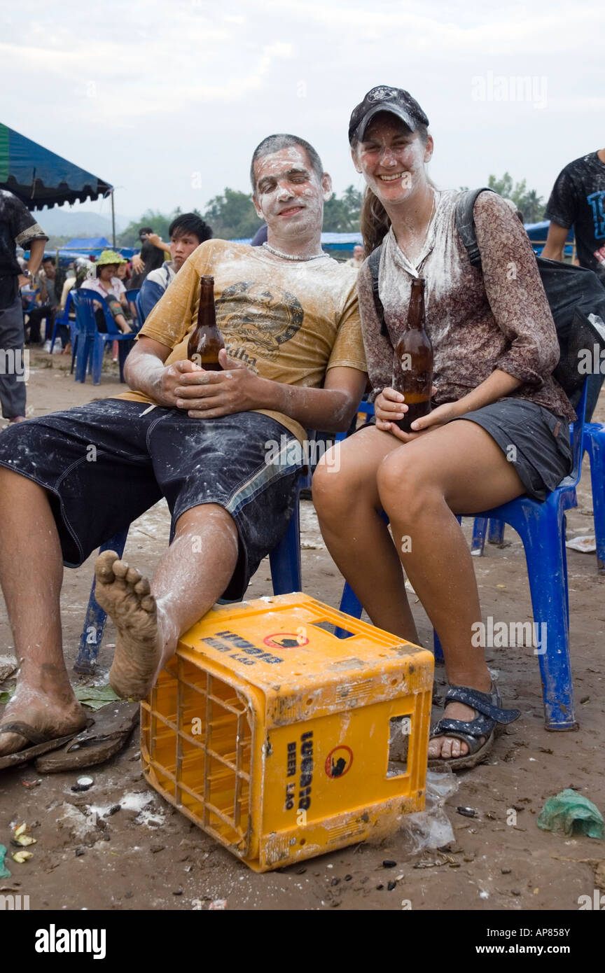 Two tourists covered with flour at the sand stupa making party on the ...